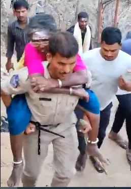 Cop wins hearts carrying woman devotee on his back on rocky terrain