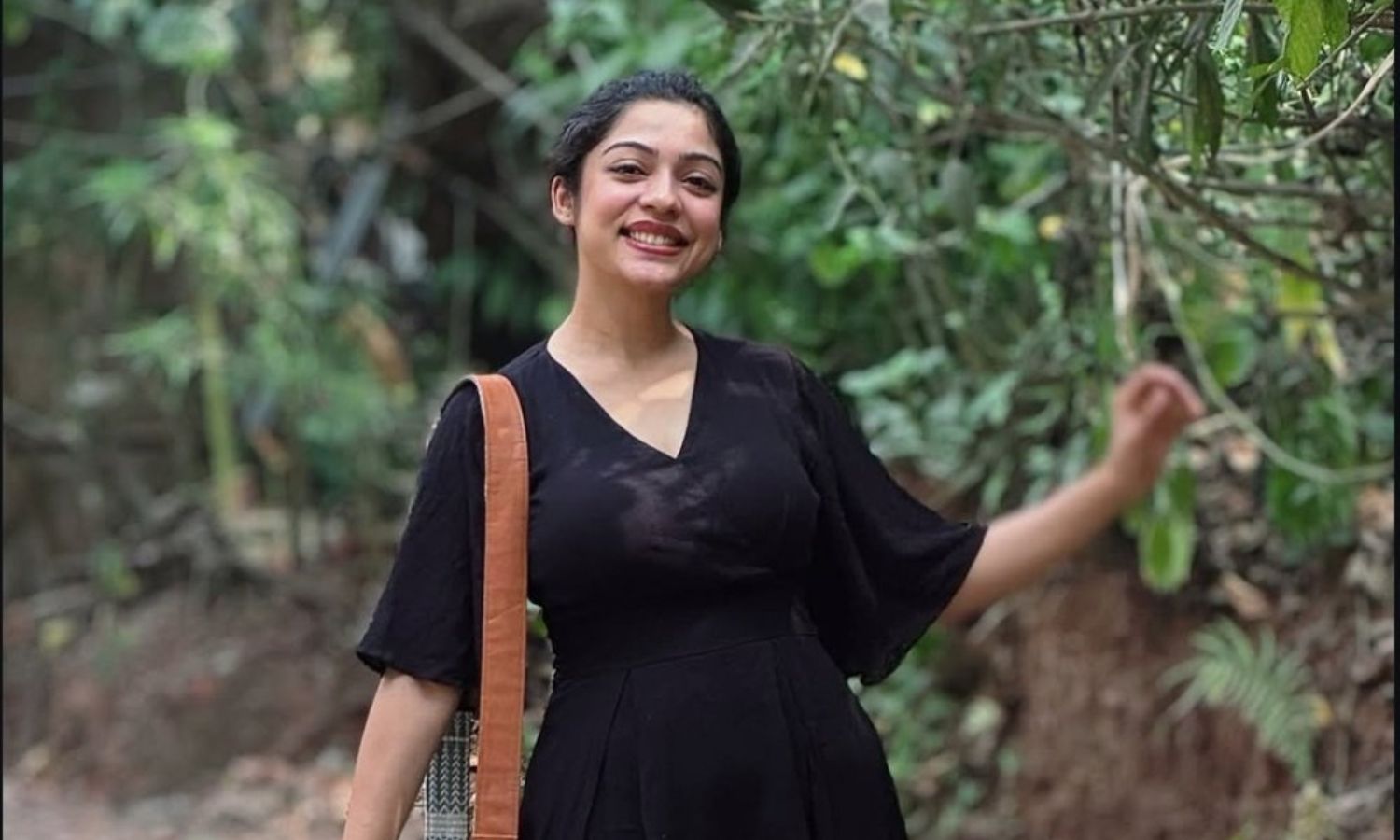Varsha Bollamma Shines in Chic Black Dress Amid Nature's Embrace